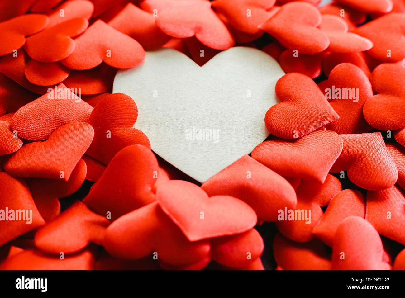 Large empty wooden heart surrounded by small red hearts for Valentine's ...