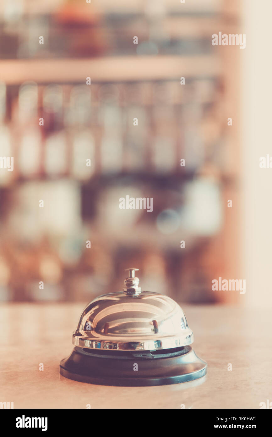 Ring bell for staff calling on the stand. Reception and bar background ...