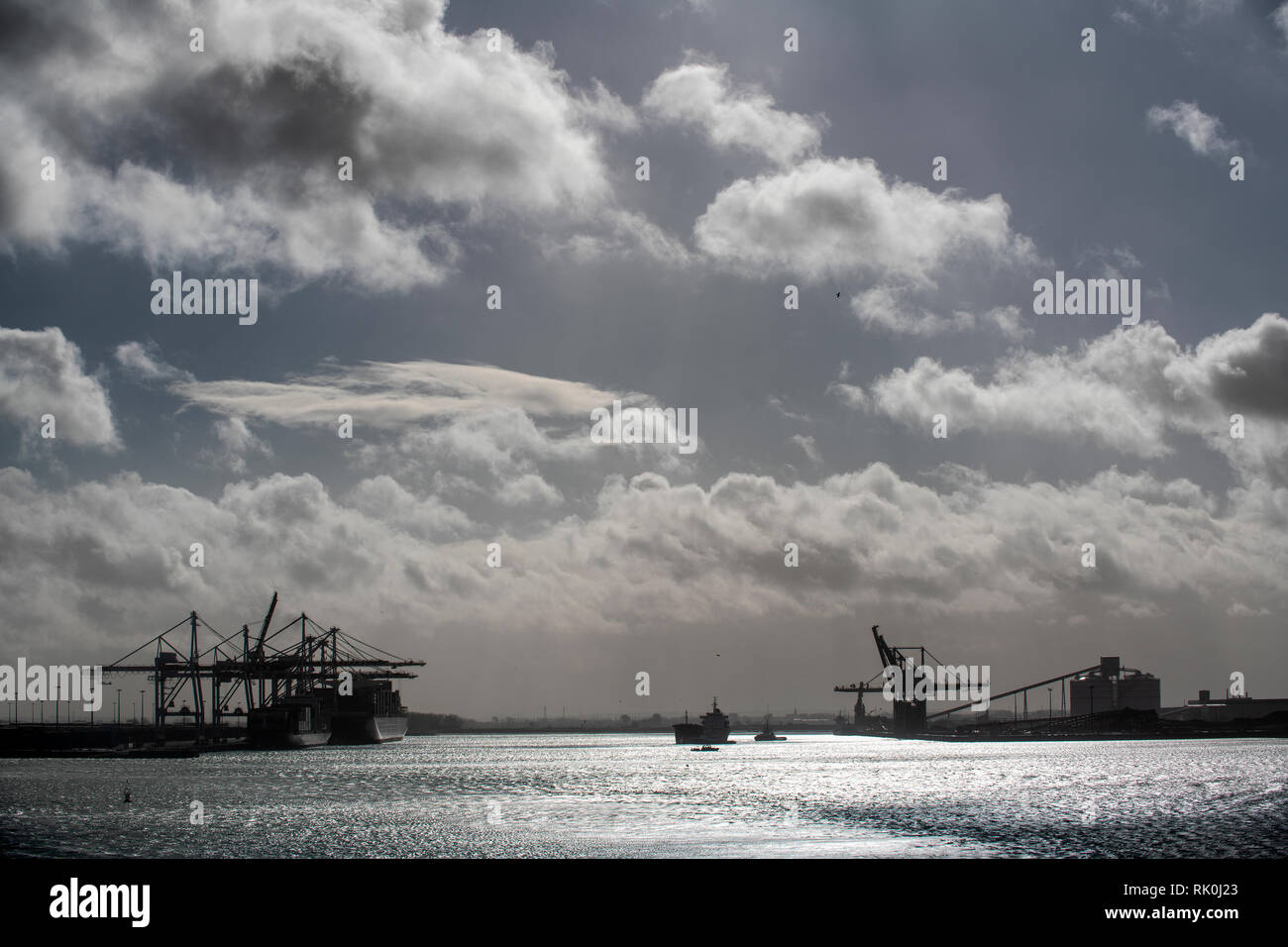 The port of Dunkerque in Northern France. Cranes load container ships ...
