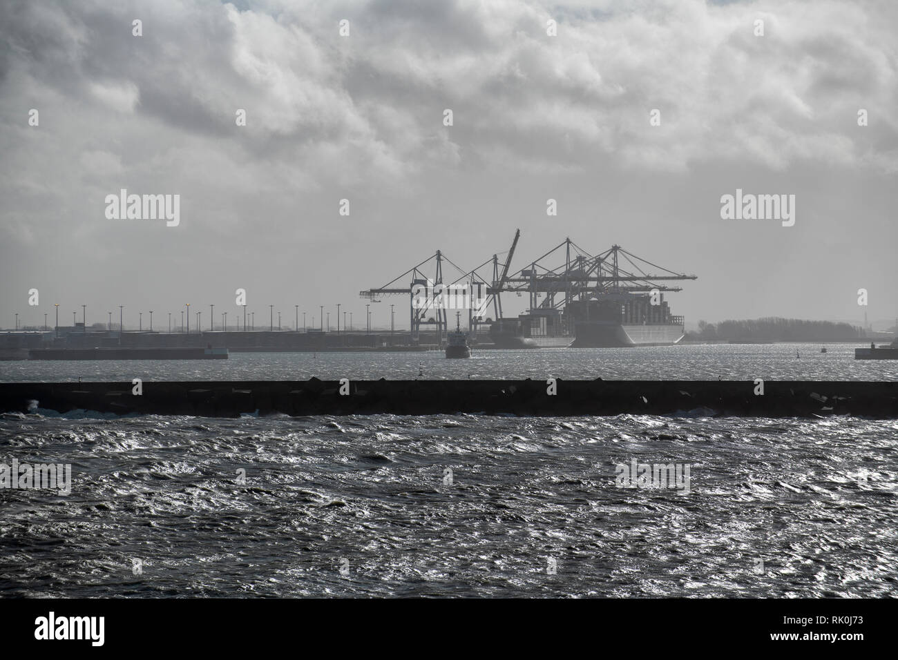 The port of Dunkerque in Northern France. Cranes load container ships ...
