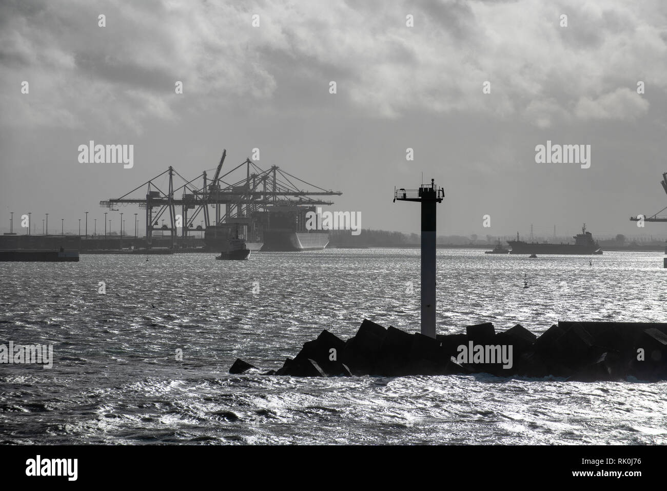 The port of Dunkerque in Northern France. Cranes load container ships ...
