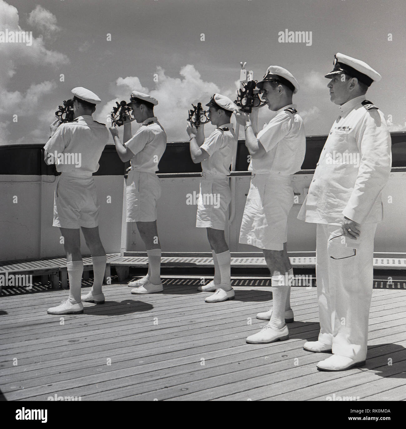1950s, historical, uniformed ship officers using sextants, traditional ...