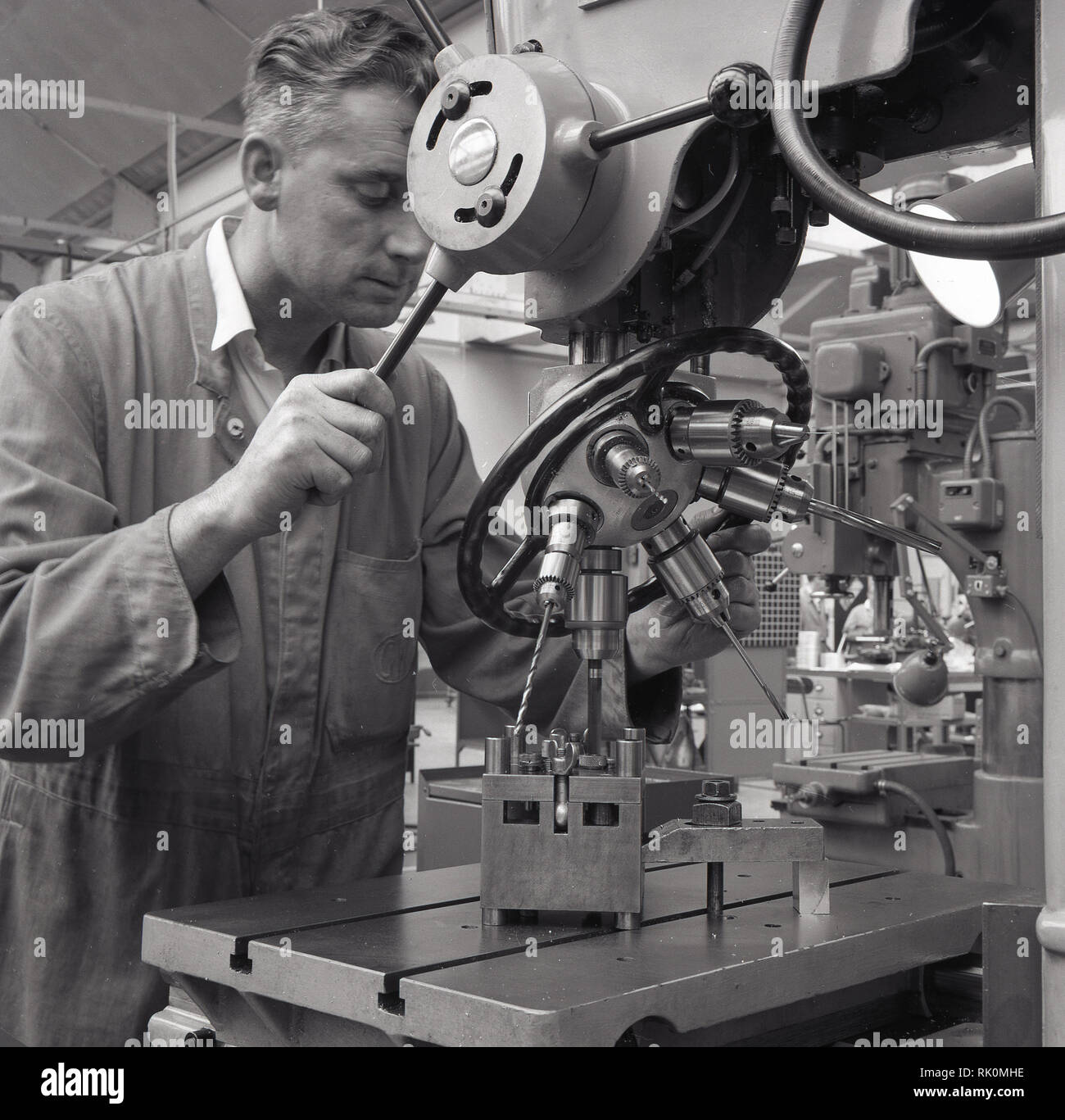 1950s, historical, engineering worker in an aviation factory, using a ...