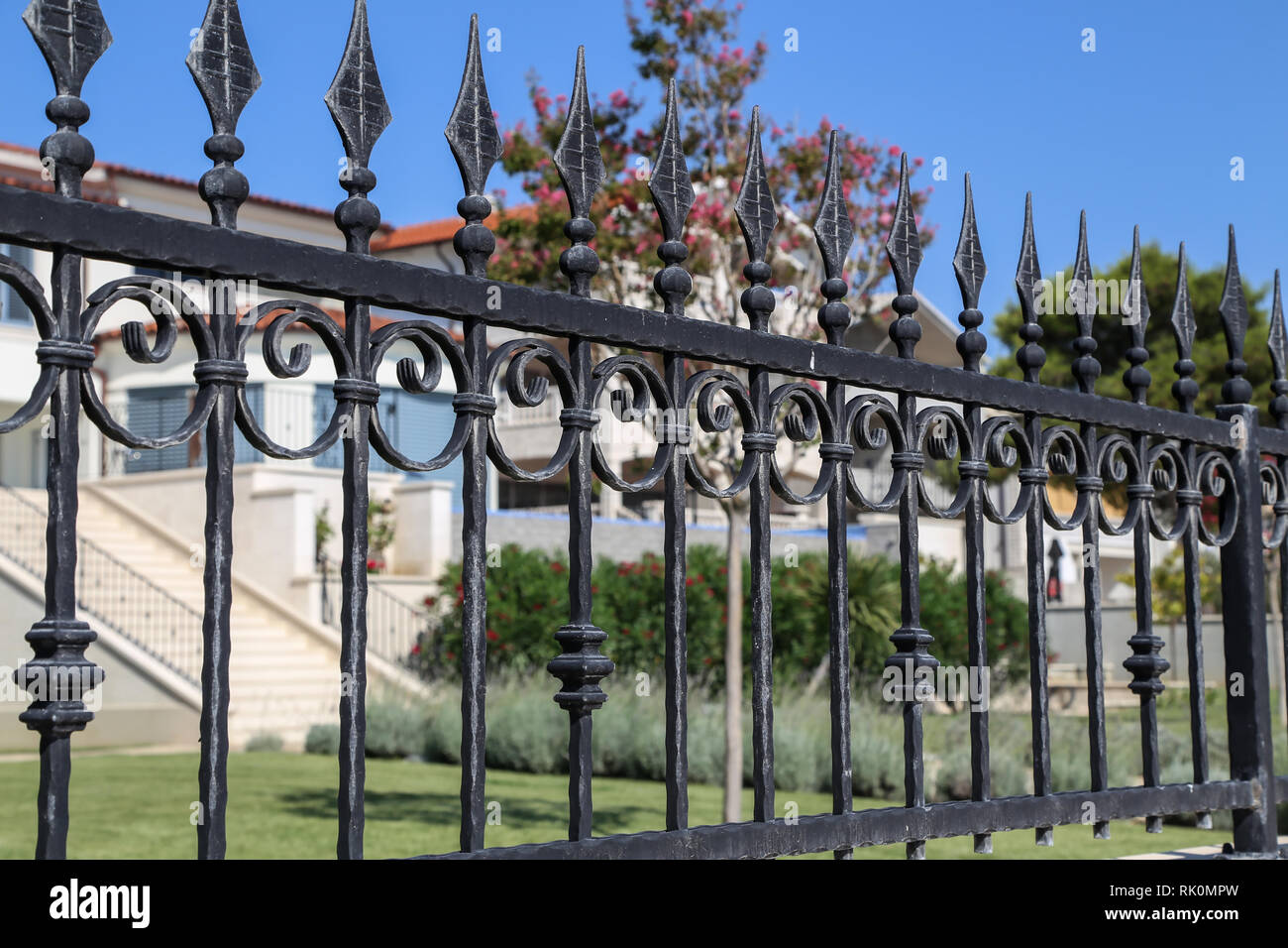 Metal fence. Metal curly fence in the park Stock Photo - Alamy