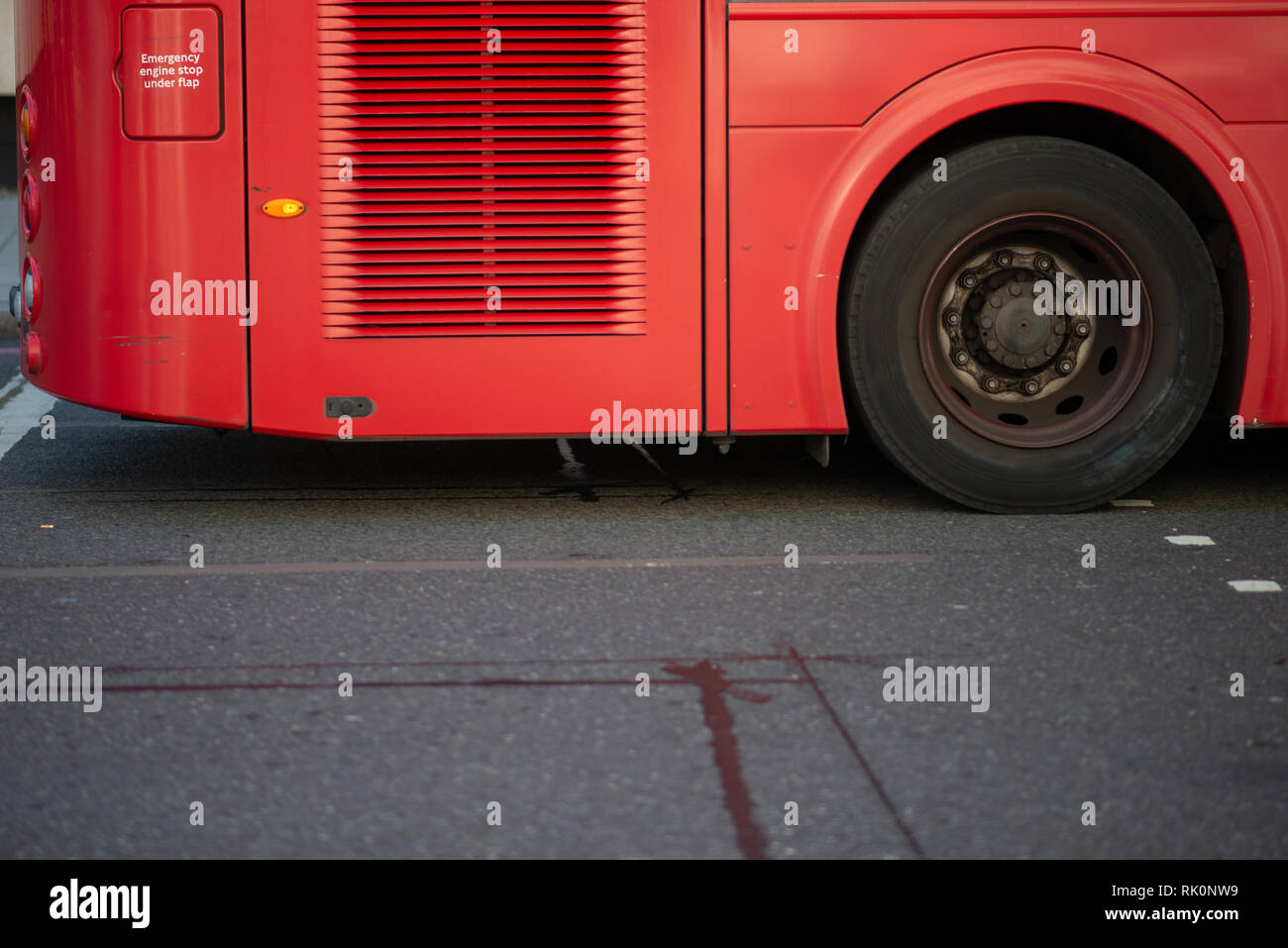rear of red london bus with one wheel showing Stock Photo - Alamy