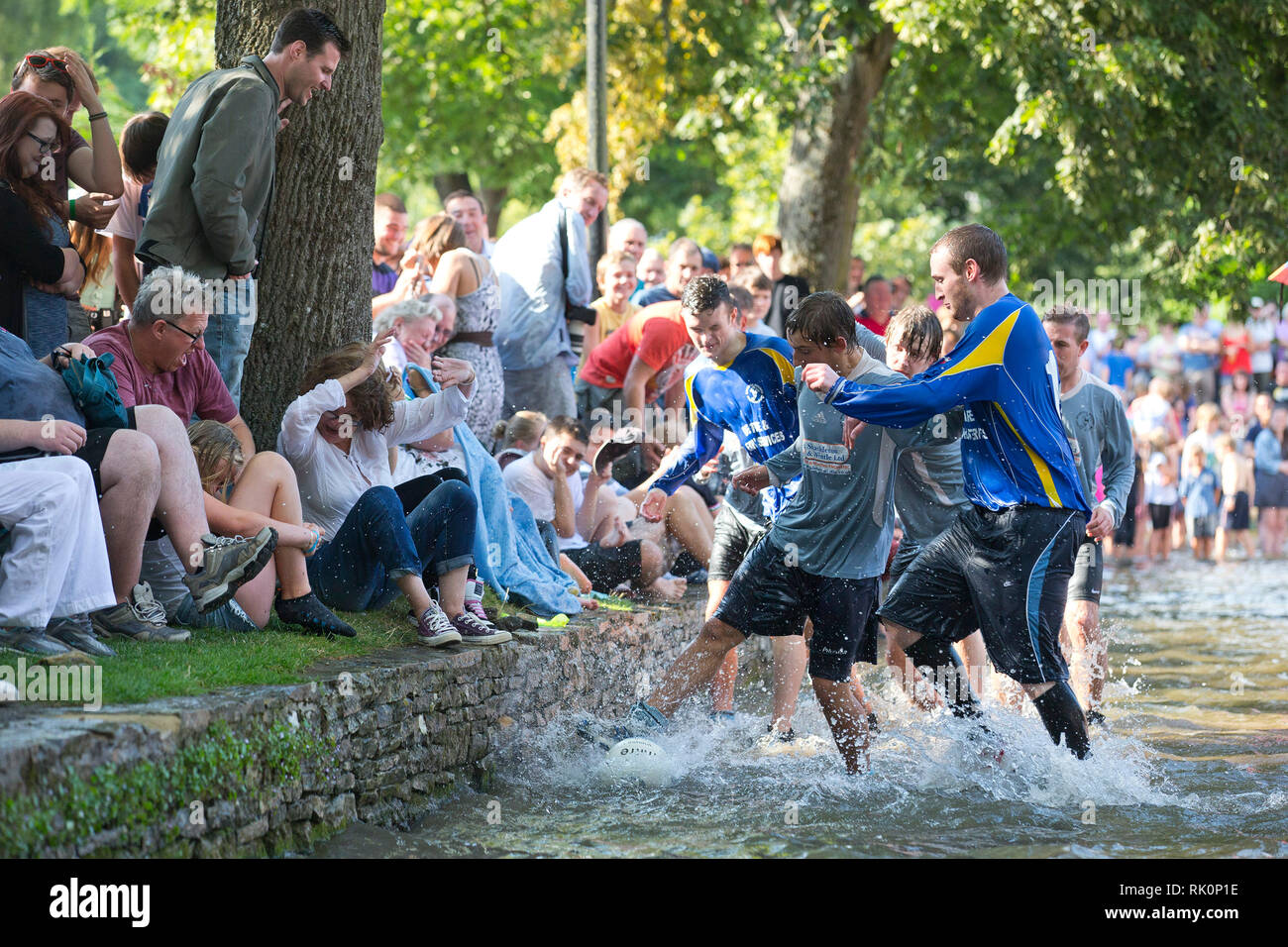 Teams play water football in the River Windrush Bourton on the water in ...