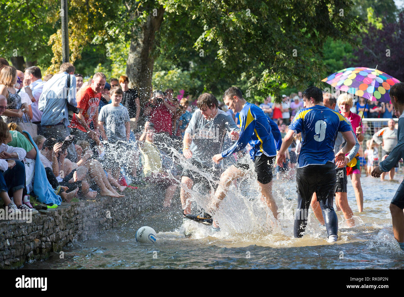 Teams play water football in the River Windrush Bourton on the water in ...
