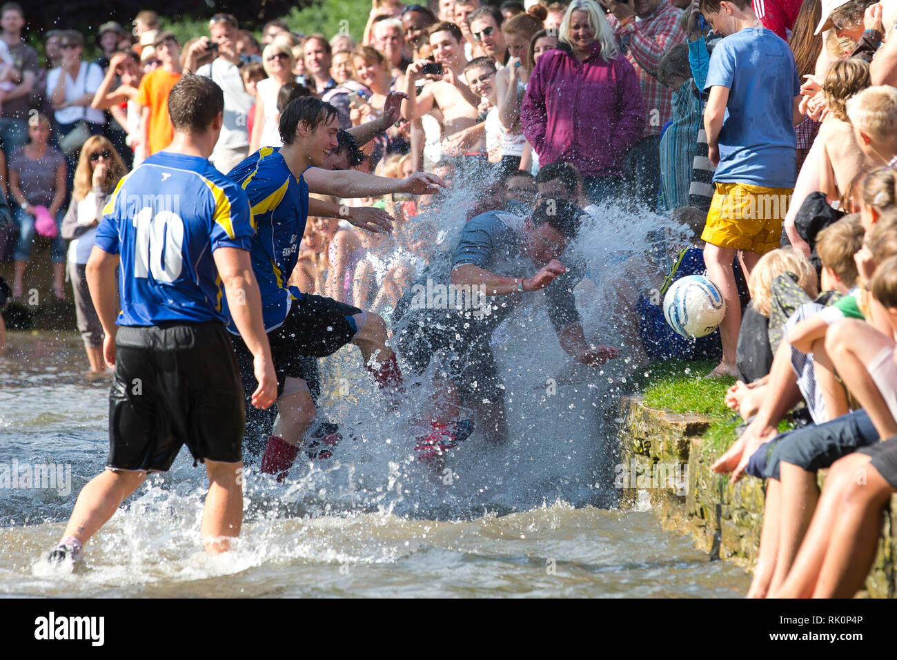Teams play water football in the River Windrush Bourton on the water in ...