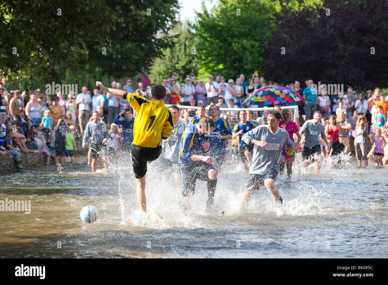 Teams play water football in the River Windrush Bourton on the water in ...