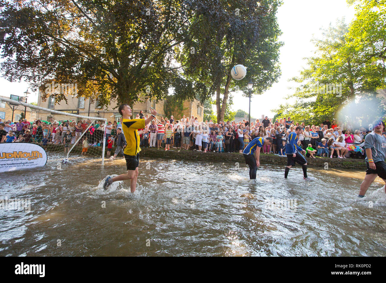 Teams play water football in the River Windrush Bourton on the water in ...
