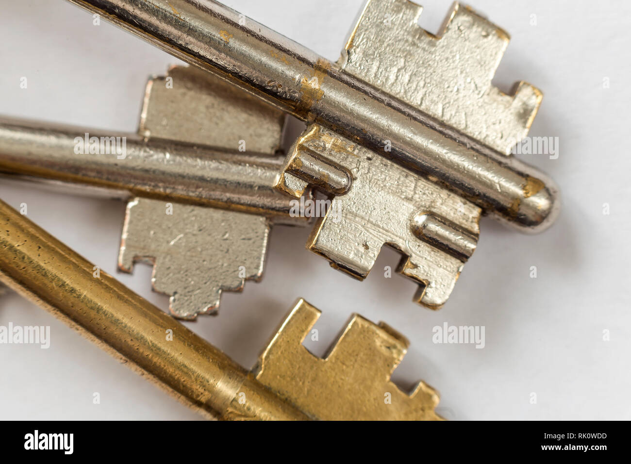 Close-up detail of old metallic keys stainless and yellow isolated on ...