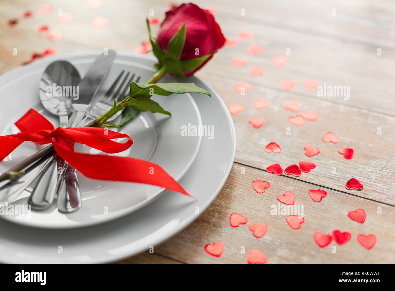 close up of red rose flower on set of dishes Stock Photo - Alamy