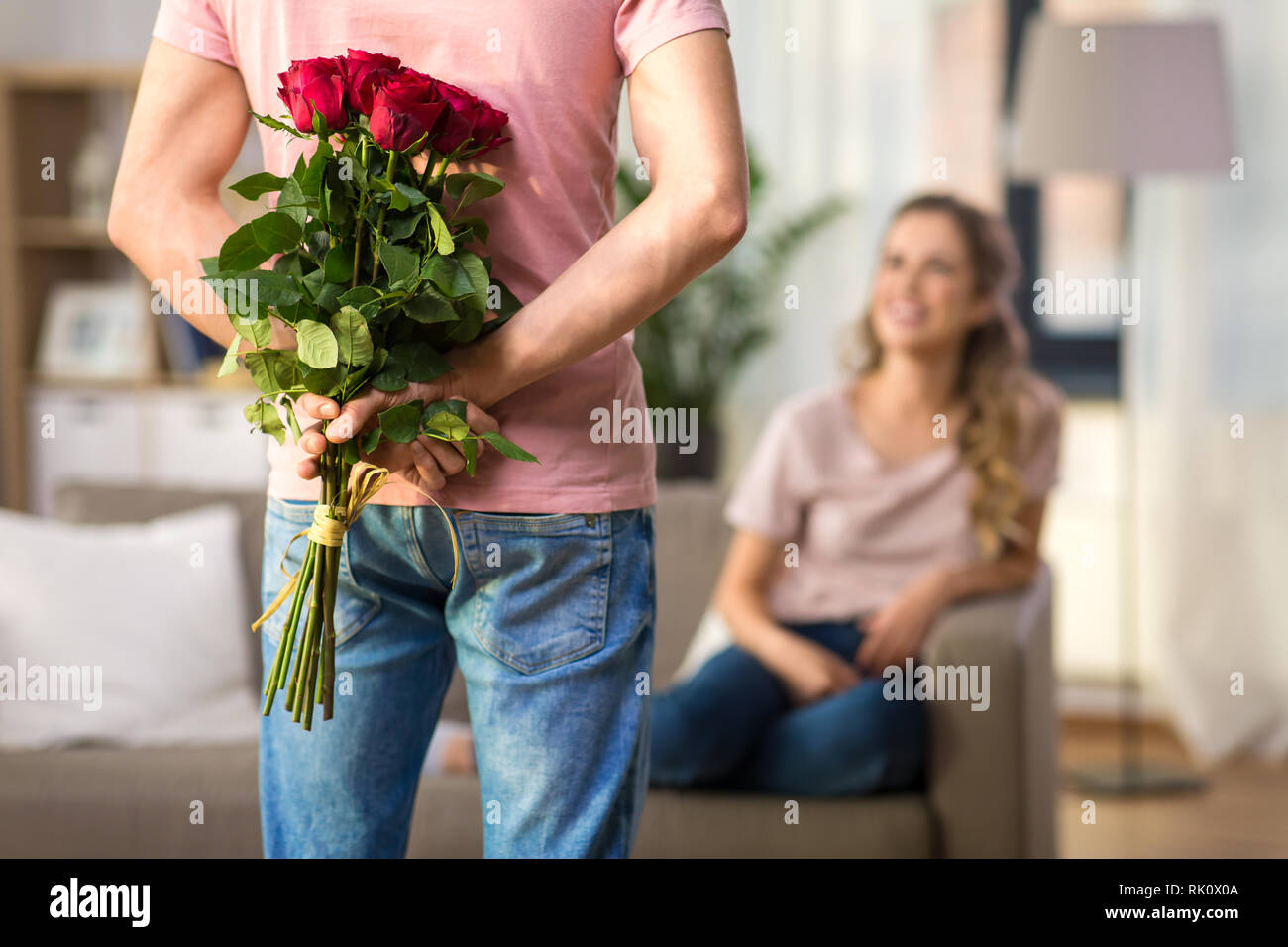 Husband hiding flower behind back hi-res stock photography and images ...