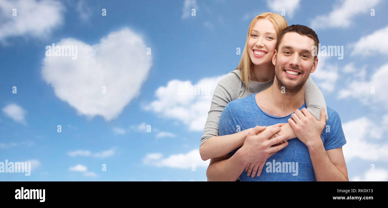 couple hugging over sky and heart shaped cloud Stock Photo - Alamy