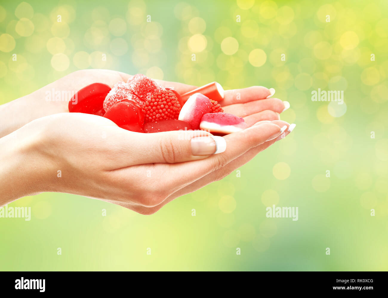close up of hands holding red jelly candies Stock Photo - Alamy