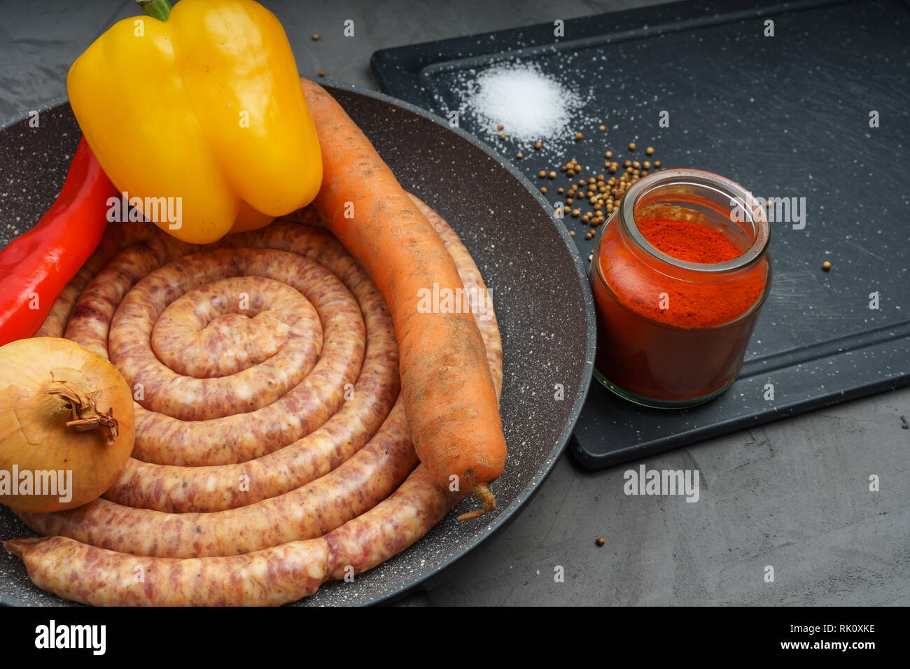 First page menu pork saussage with ingredients, raw food on dark desk ...