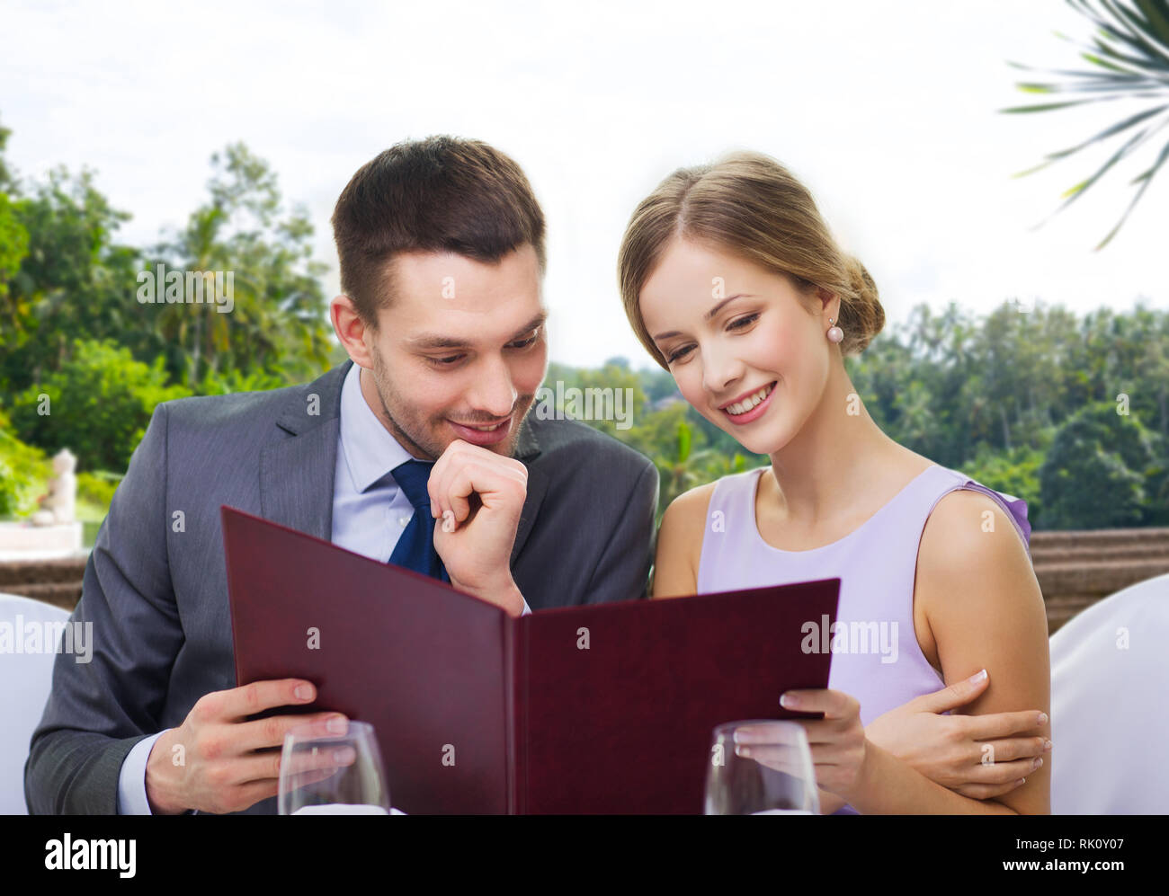 couple with menu at restaurant Stock Photo - Alamy