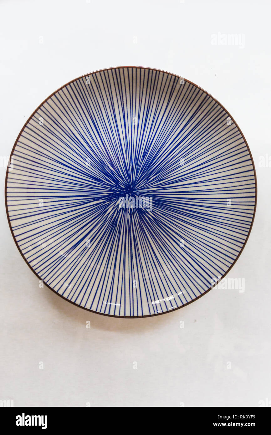 a blue round plate with line pattern on white background Stock Photo ...