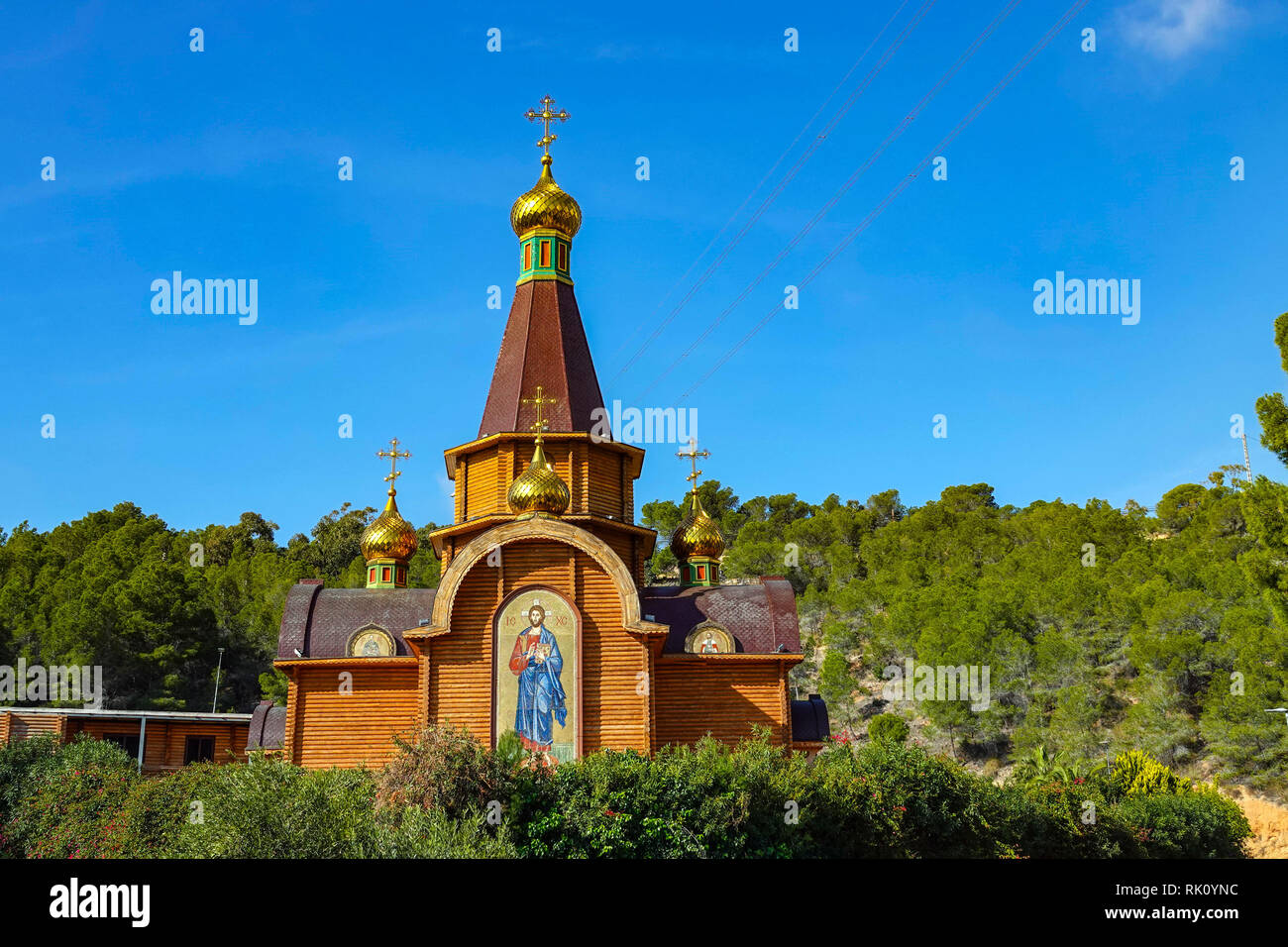 wooden Russian Orthodox church with gold cross against blue sky, Altea ...