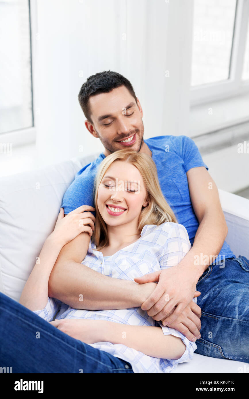 Woman hugging man sofa hi-res stock photography and images - Alamy