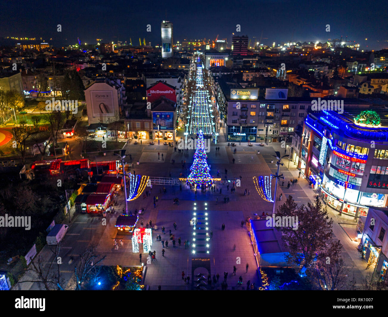 Drone top view.Many people are skating at the rink in "Troikata" square ...