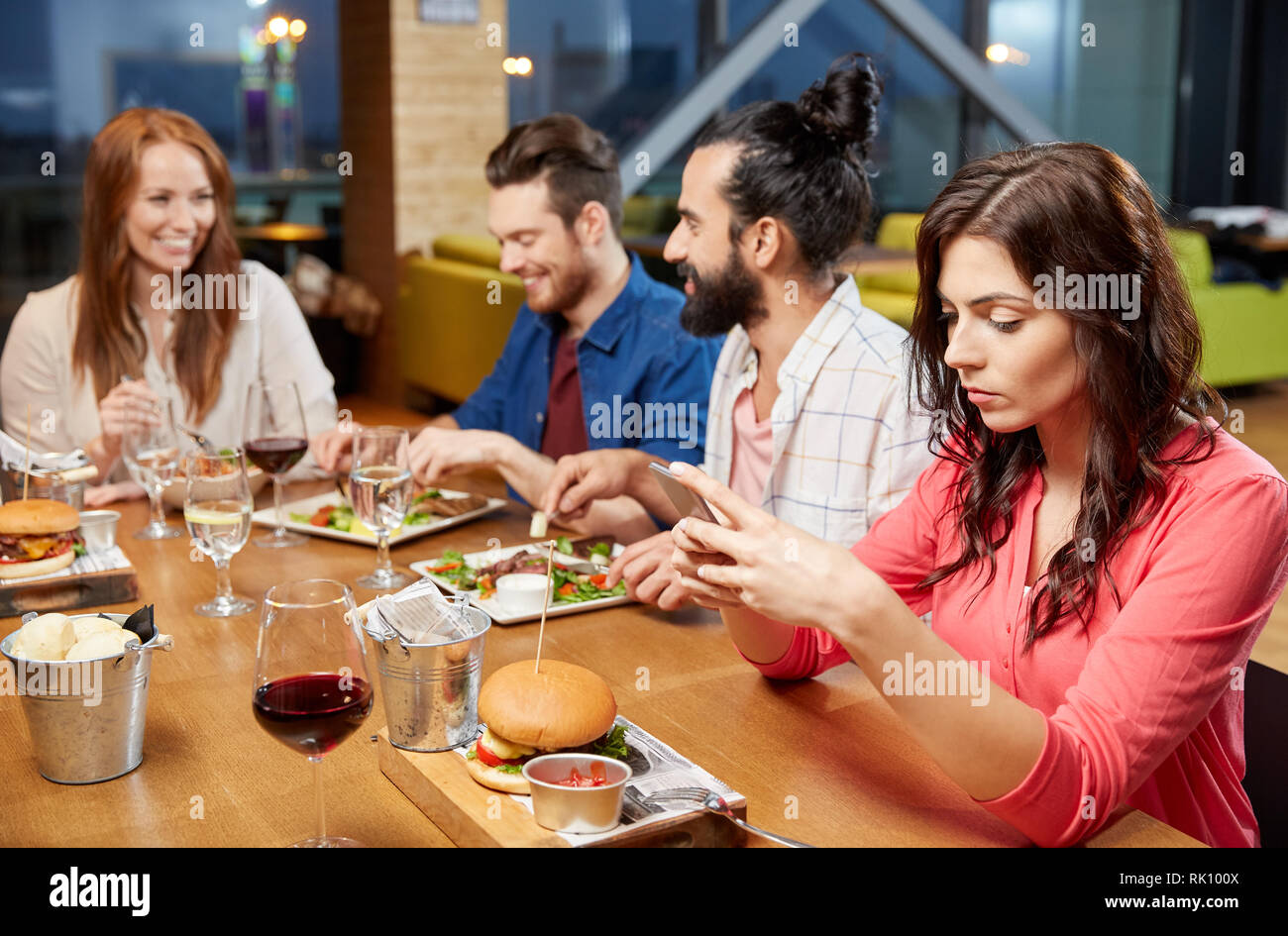 bored woman messaging on smartphone at restaurant Stock Photo - Alamy