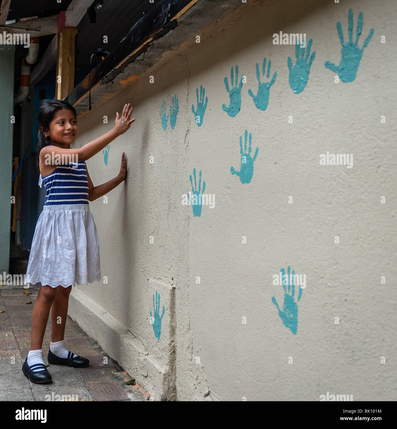 young latin girl making hand prints in Guatemala Stock Photo - Alamy