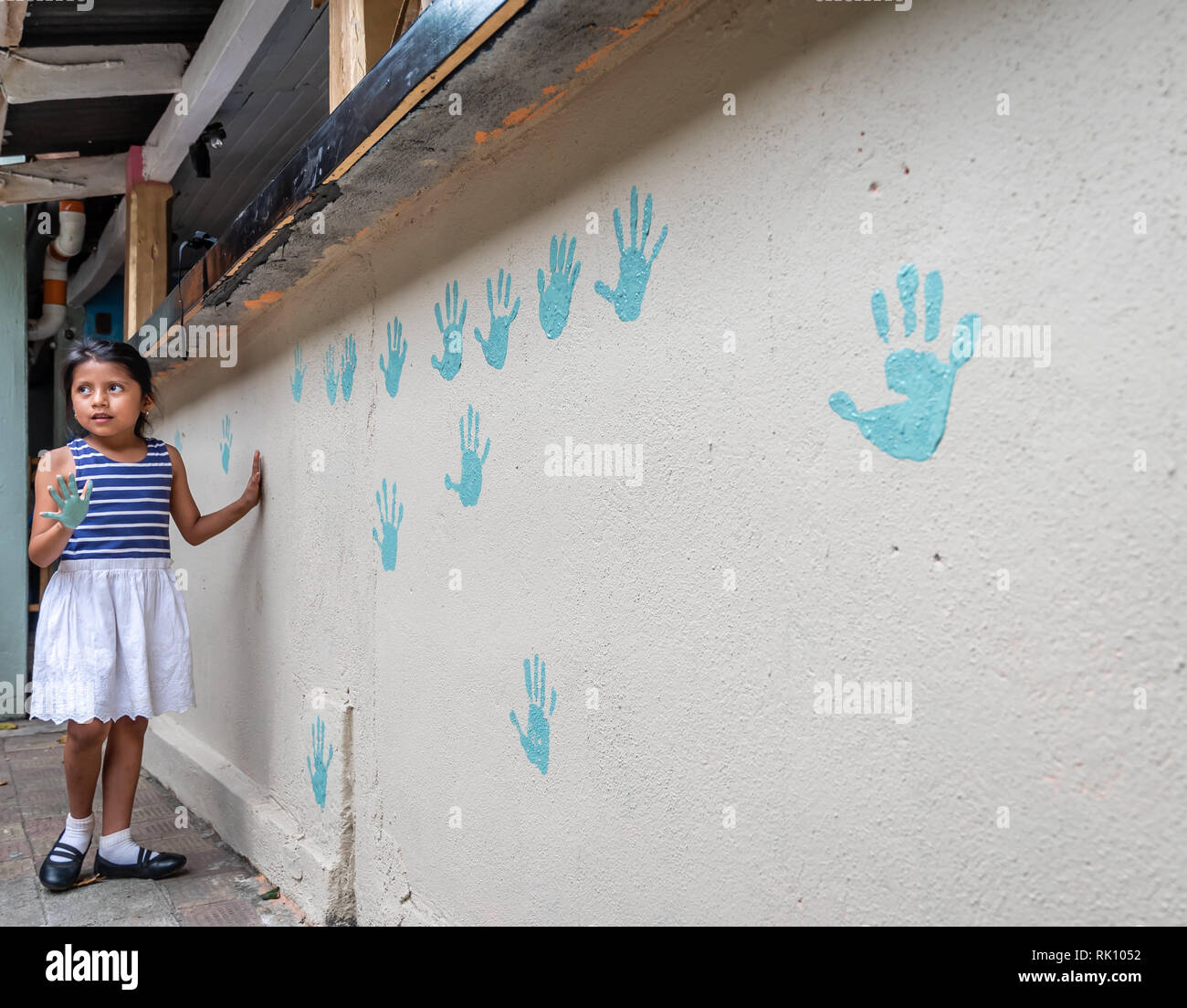 young latin girl making hand prints in Guatemala Stock Photo - Alamy
