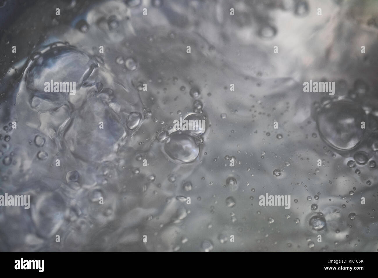 Boiling water in a pot, bubbles, abstract background. Global warming ...
