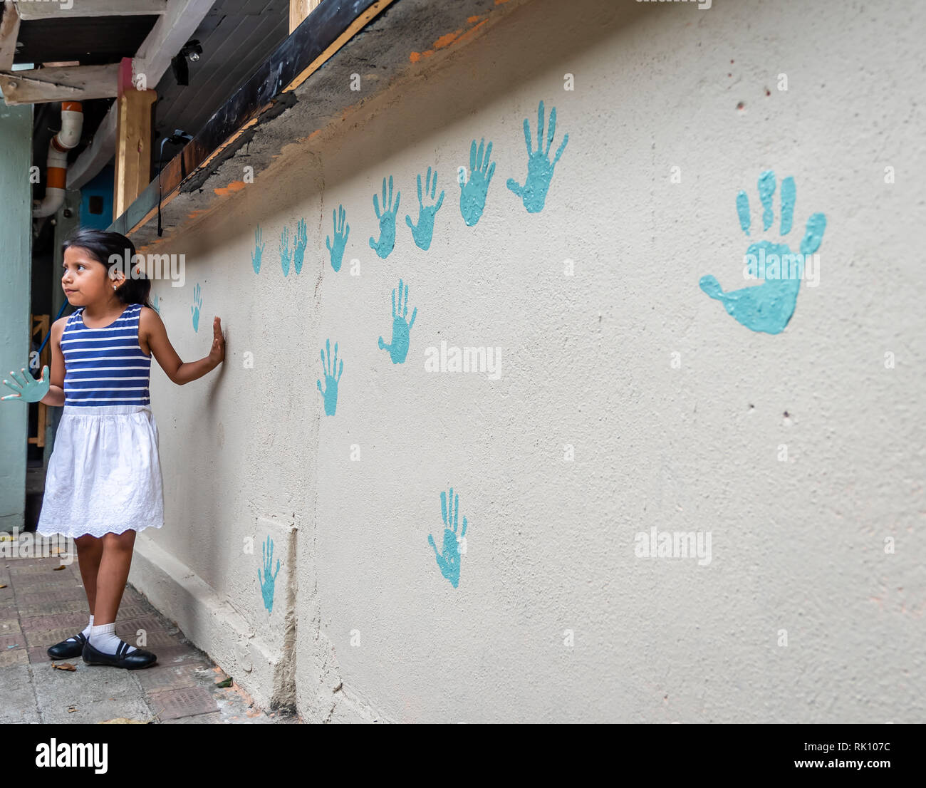 young latin girl making hand prints in Guatemala Stock Photo - Alamy