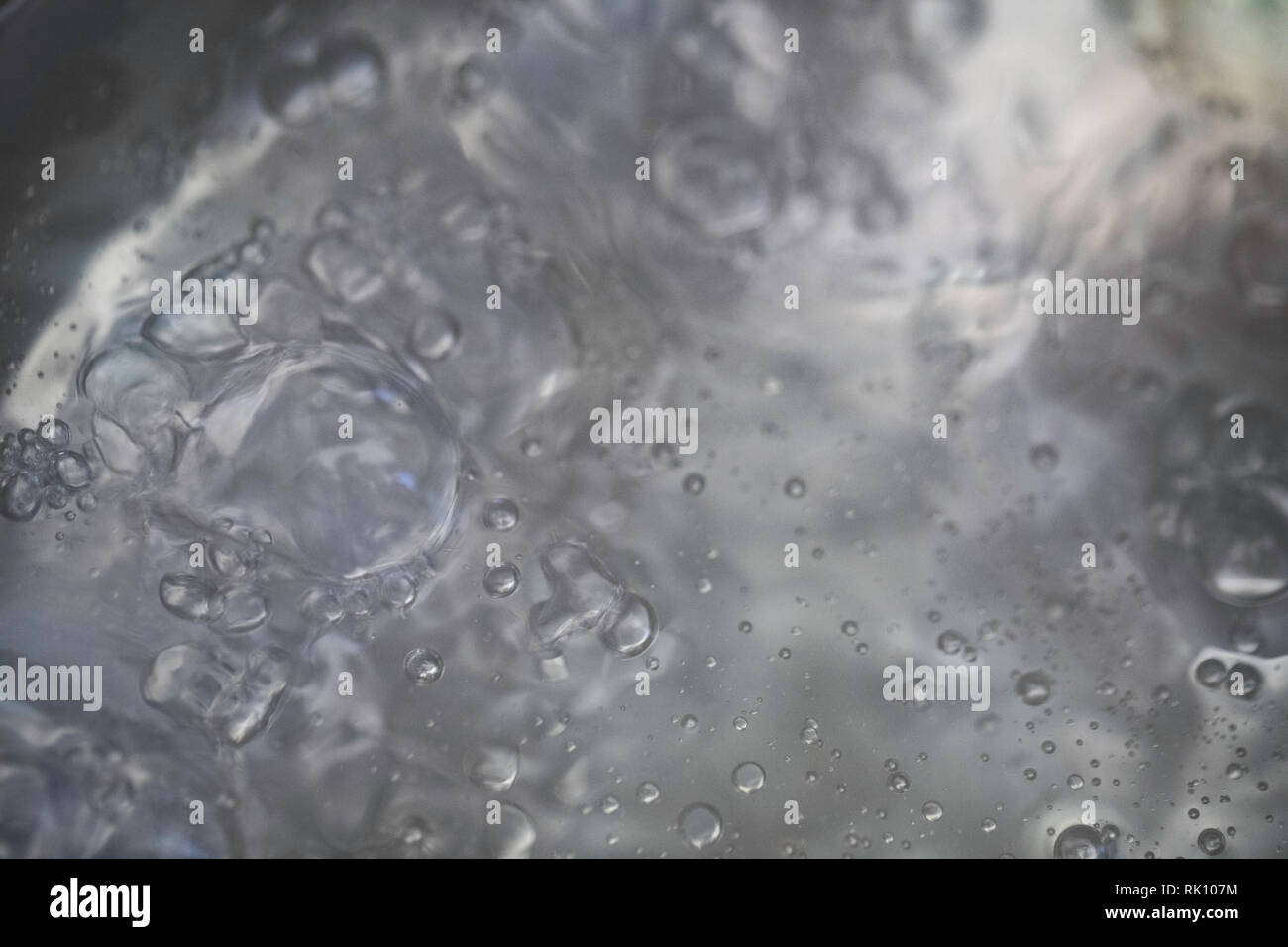 Boiling water in a pot, bubbles, abstract background. Global warming ...