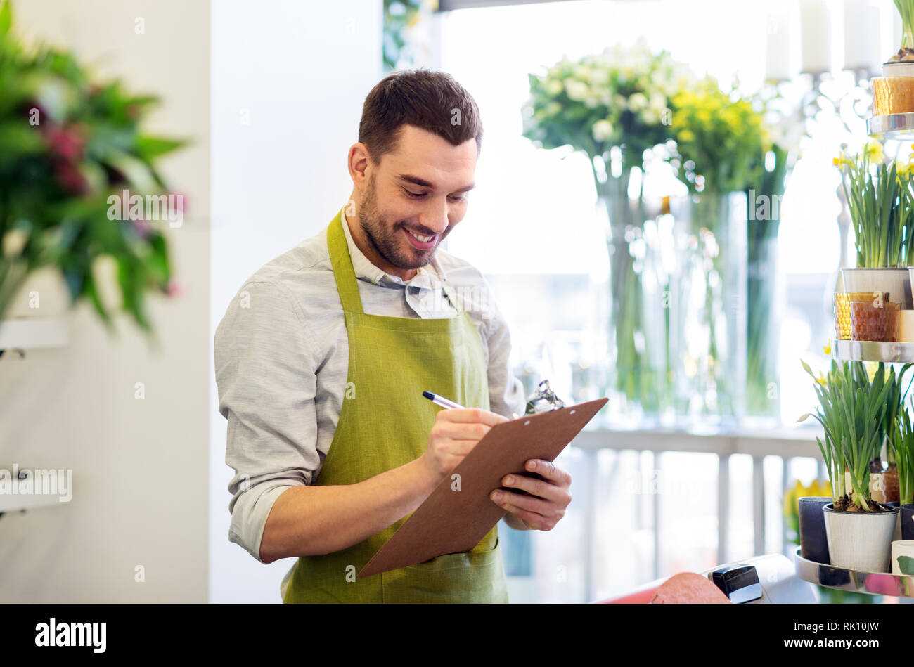 florist man with clipboard at flower shop counter Stock Photo - Alamy