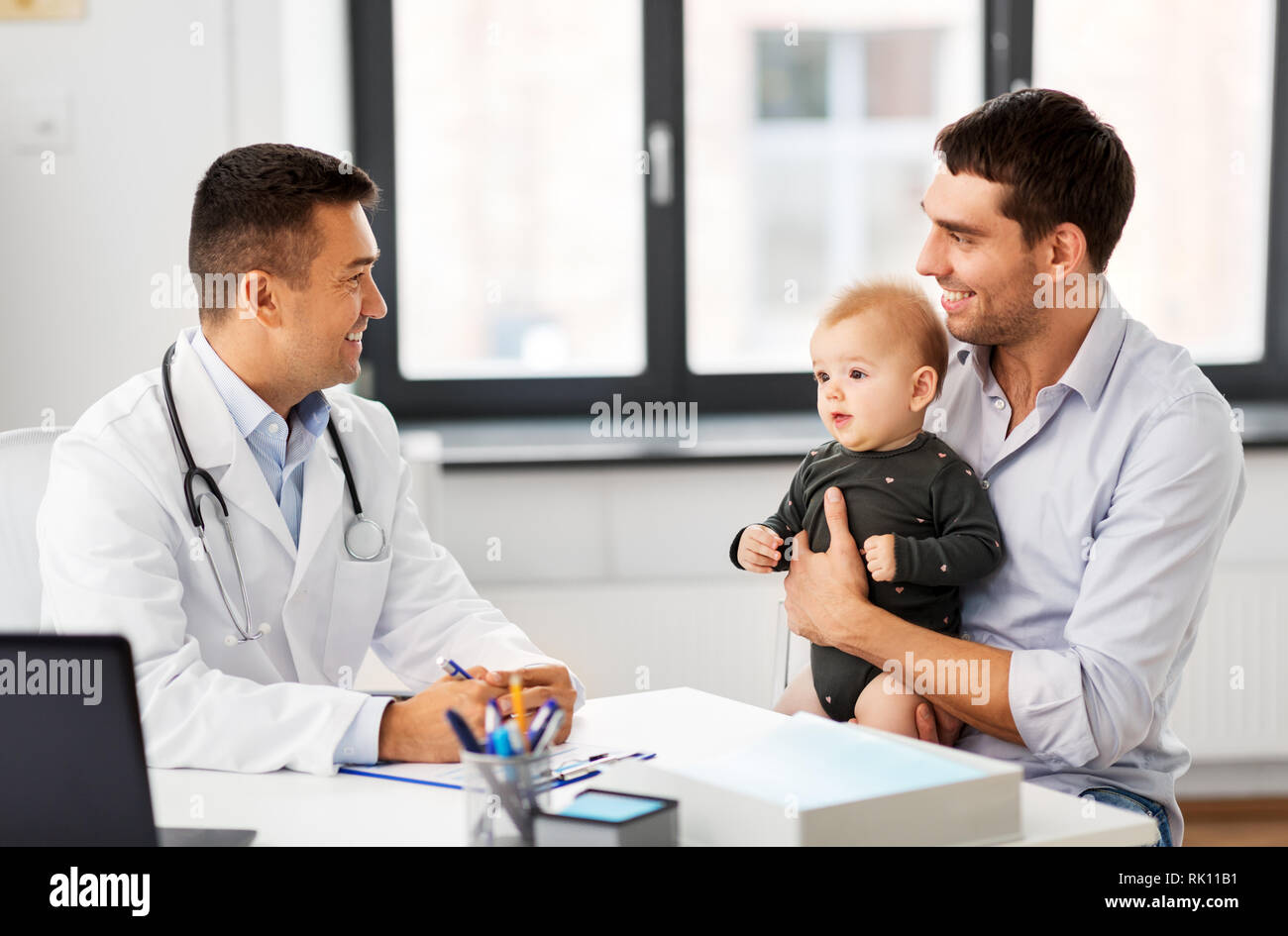 father with baby and doctor at clinic Stock Photo - Alamy