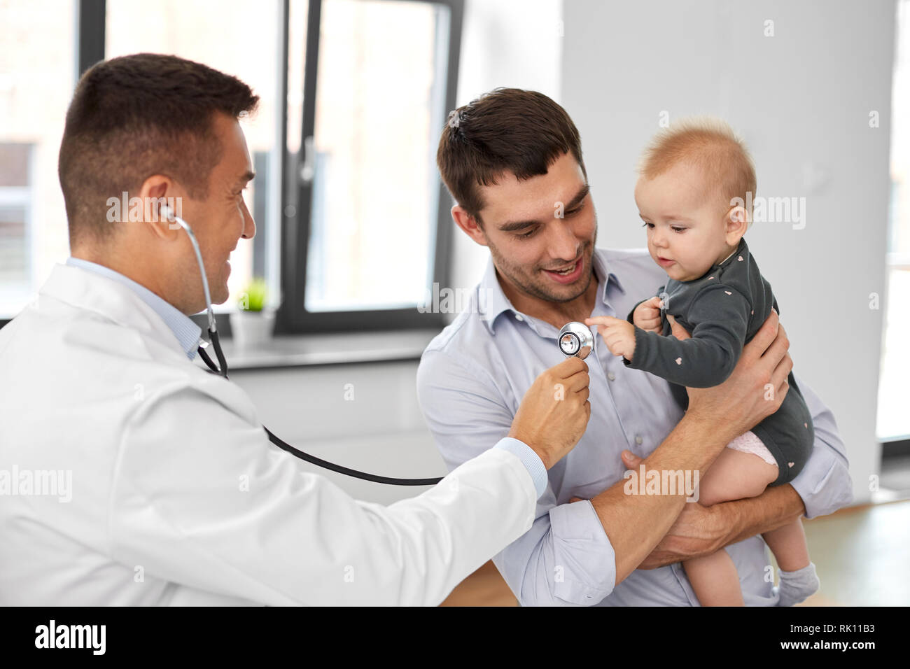 father with baby and doctor at clinic Stock Photo - Alamy
