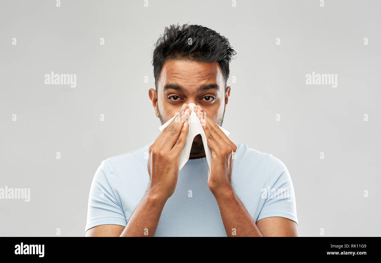 indian man with paper napkin blowing nose Stock Photo - Alamy