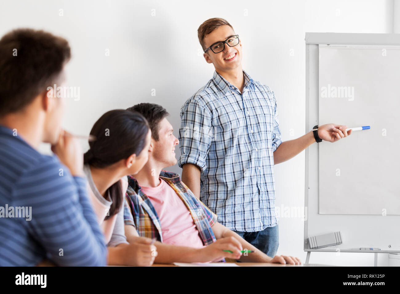 group of high school students with flip chart Stock Photo - Alamy