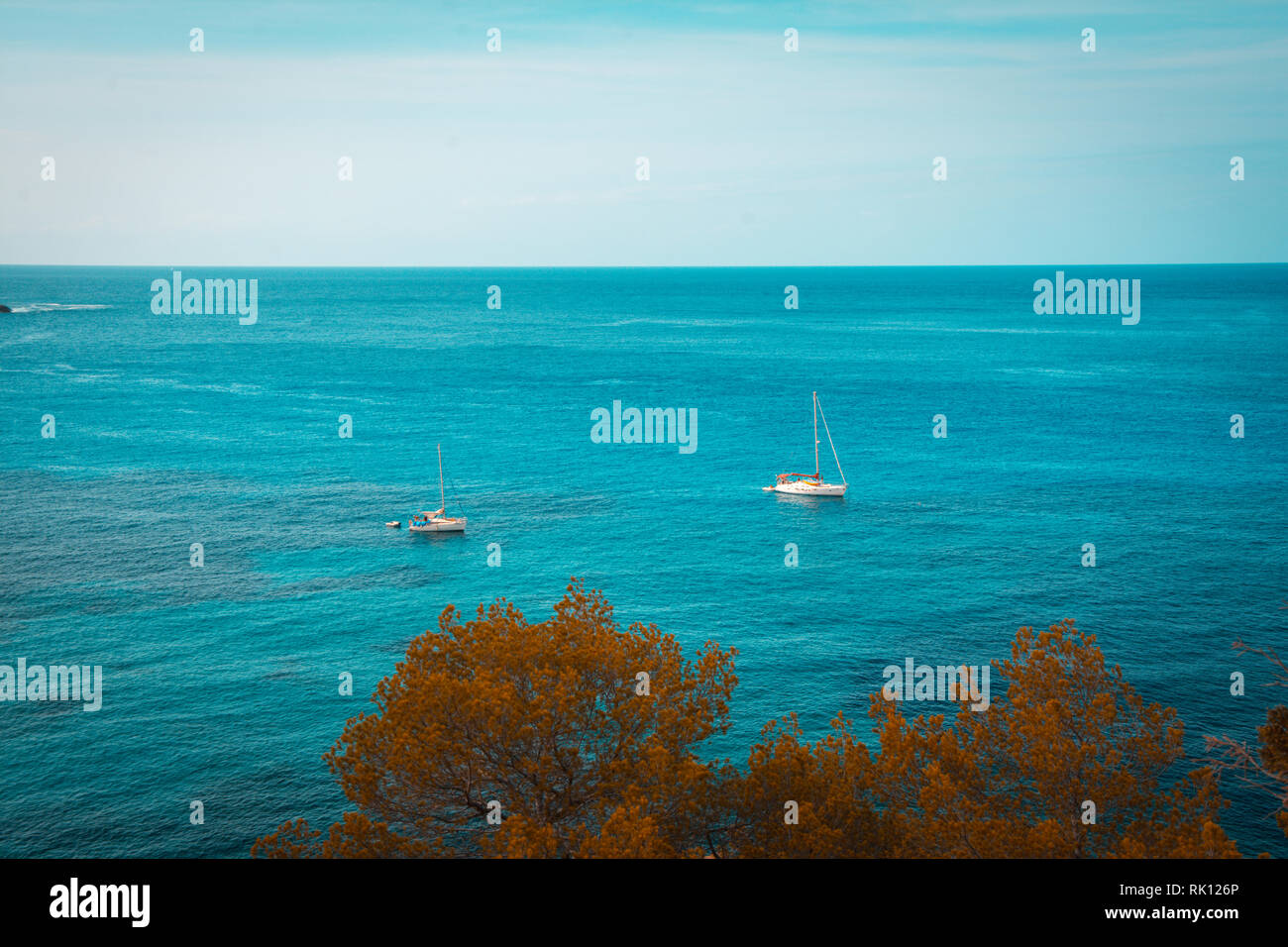 Two Sailing boat on blue mediterranean water in Ibiza island Stock ...