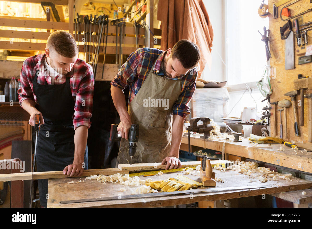 carpenters working with wooden board at workshop Stock Photo - Alamy