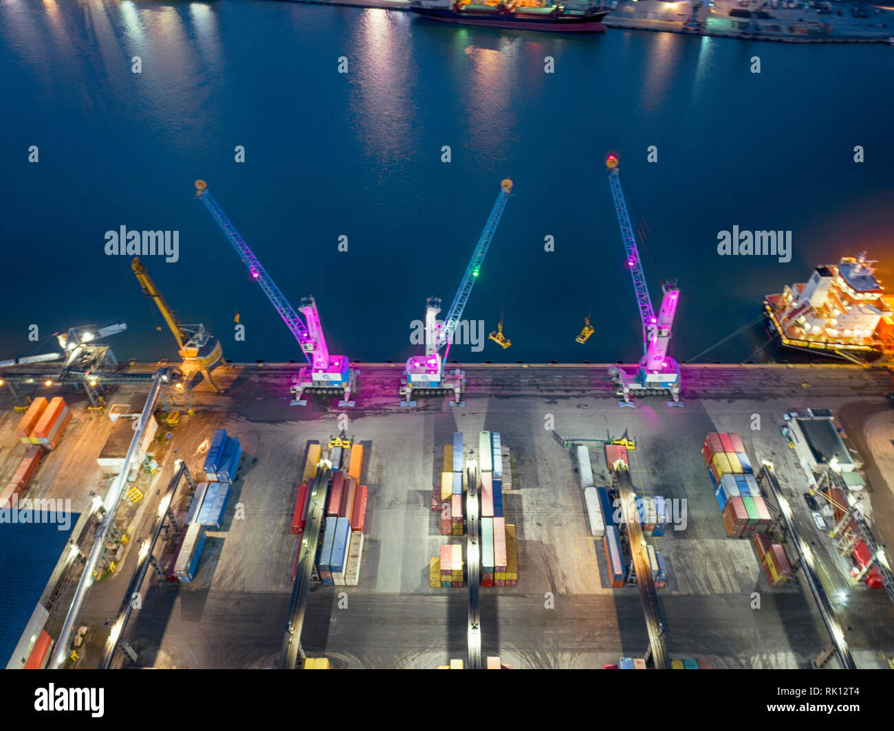 Aerial view container warehouse and working crane bridge loading ...