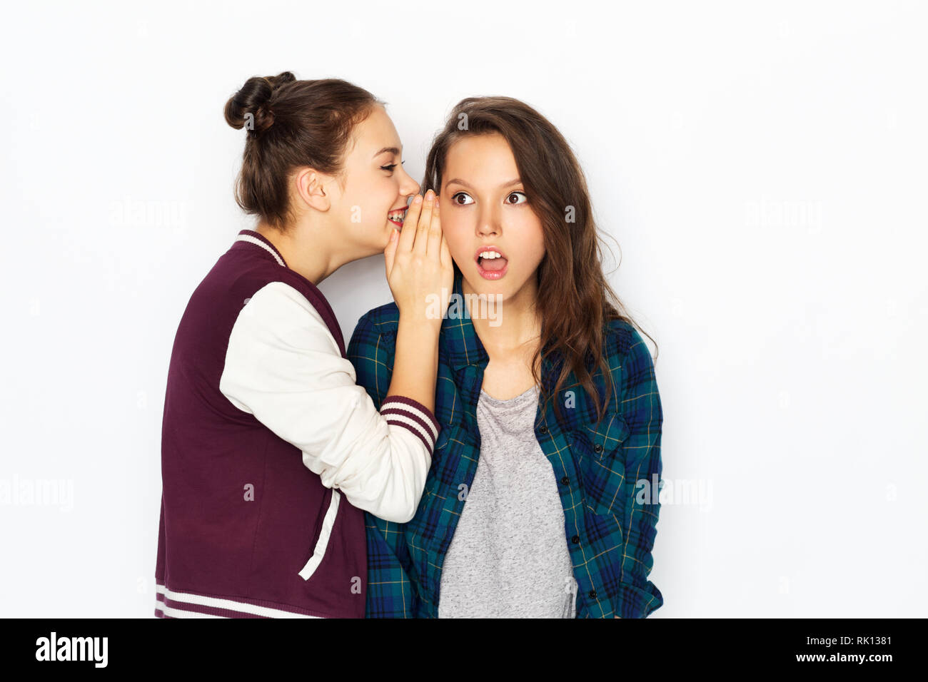 Two girls sharing secrets together hi-res stock photography and images ...