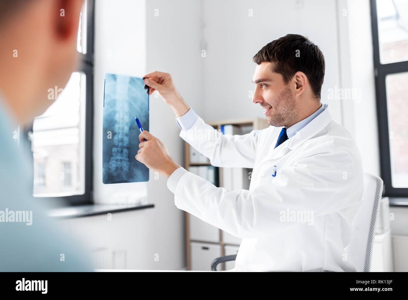 doctor showing x-ray to patient at hospital Stock Photo - Alamy