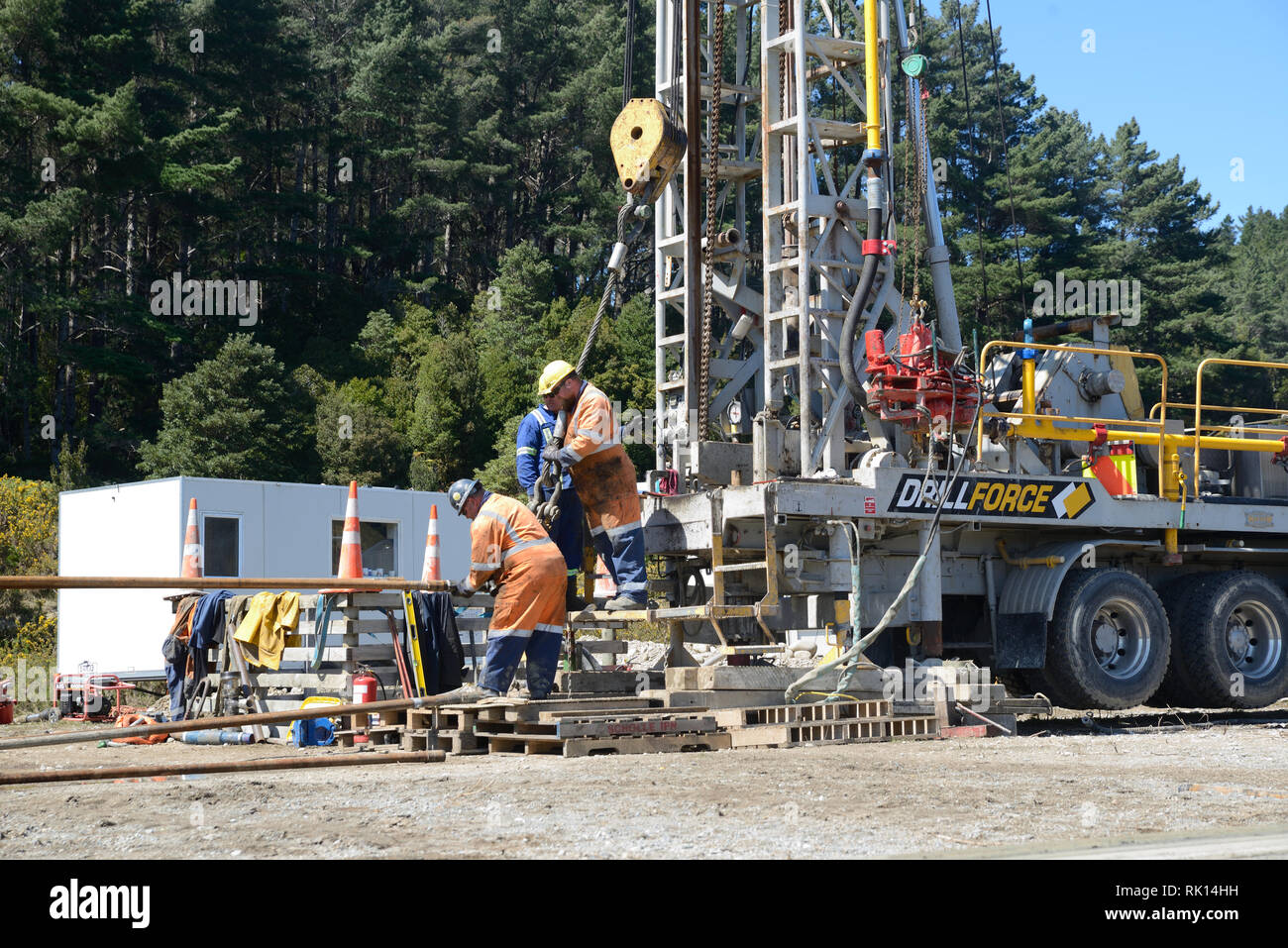 DOBSON, NEW ZEALAND, OCTOBER 13, 2018: Engineers feed the drill string ...