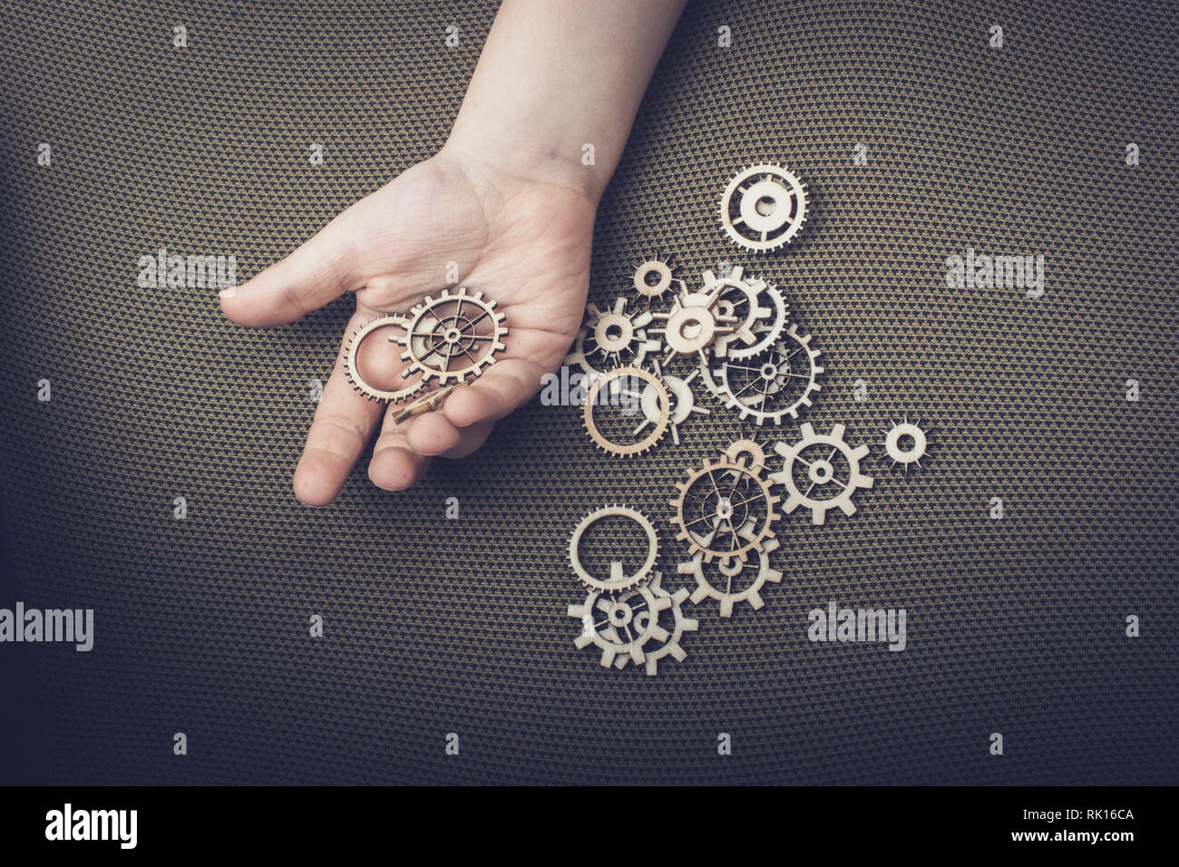 Hand holding gear wheels as the concept of mechanism Stock Photo - Alamy