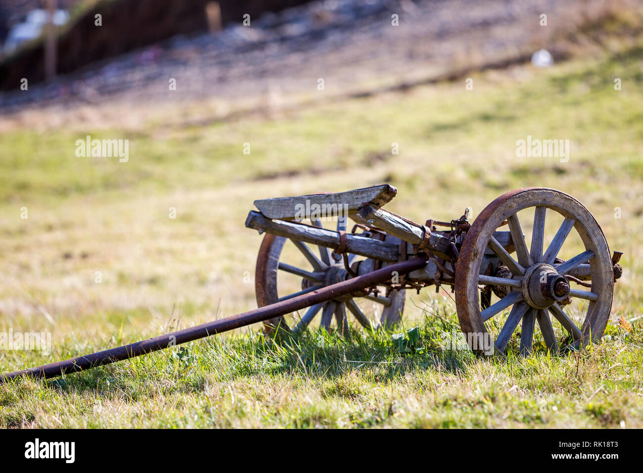 Old rusty vintage primitive wagon cart trailer with big wooden wheels ...