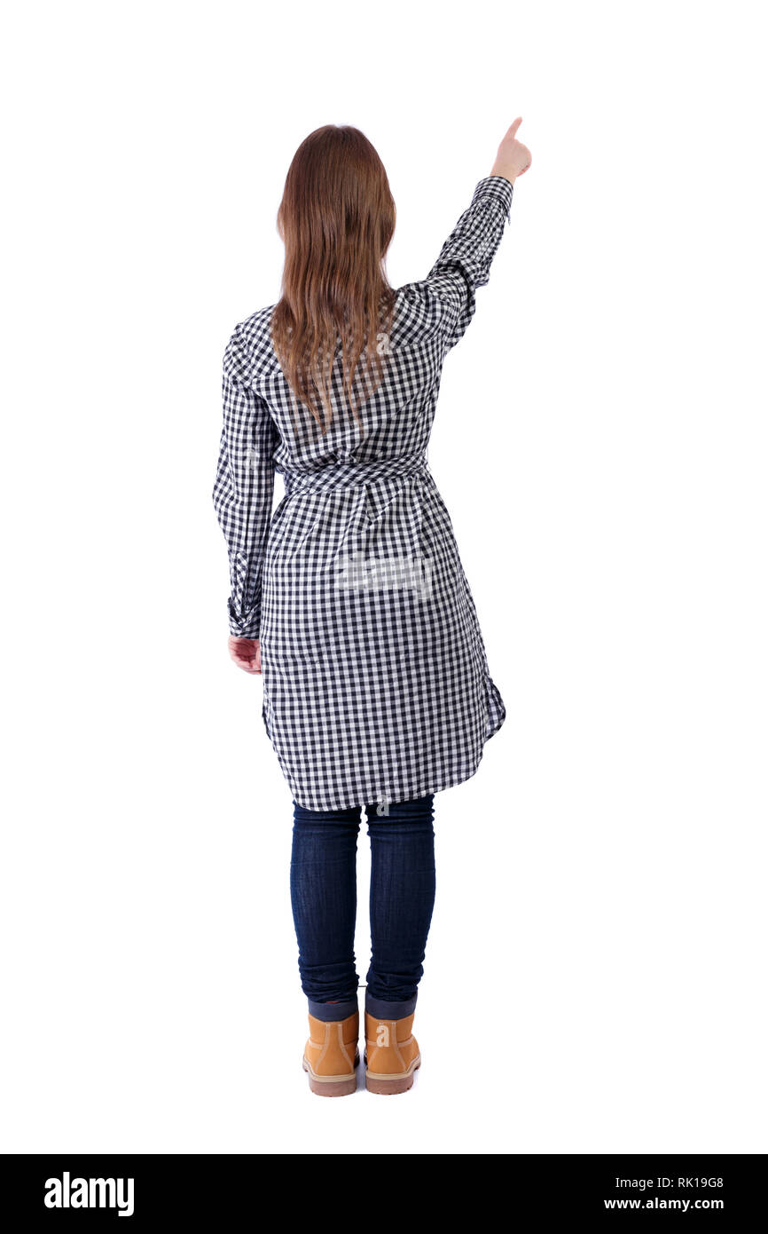 Back view of a woman in a dress points his hand upwards. Rear view ...