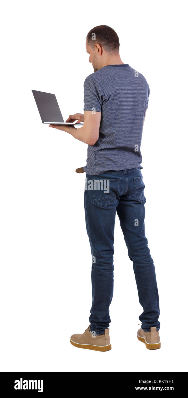 Back view of a man who is standing with a laptop. Rear view people ...