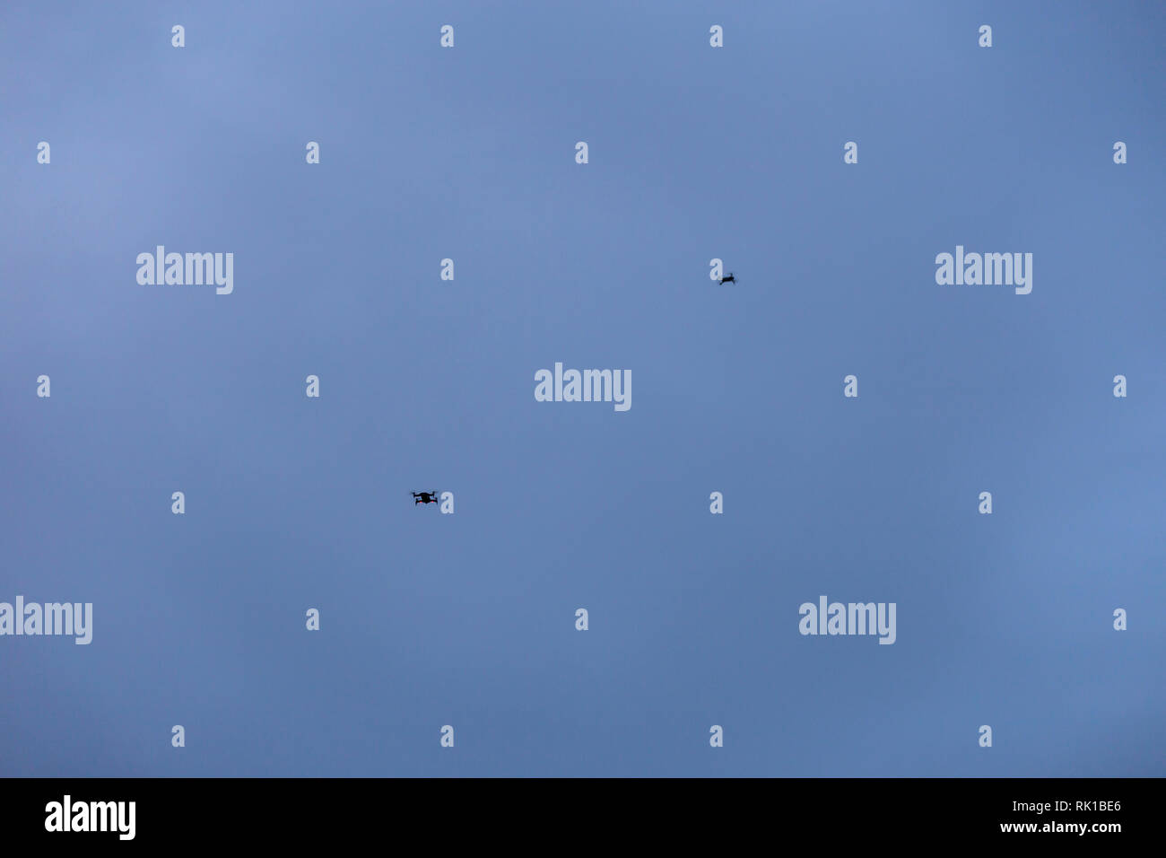 Group of drones in blue sky background Stock Photo - Alamy