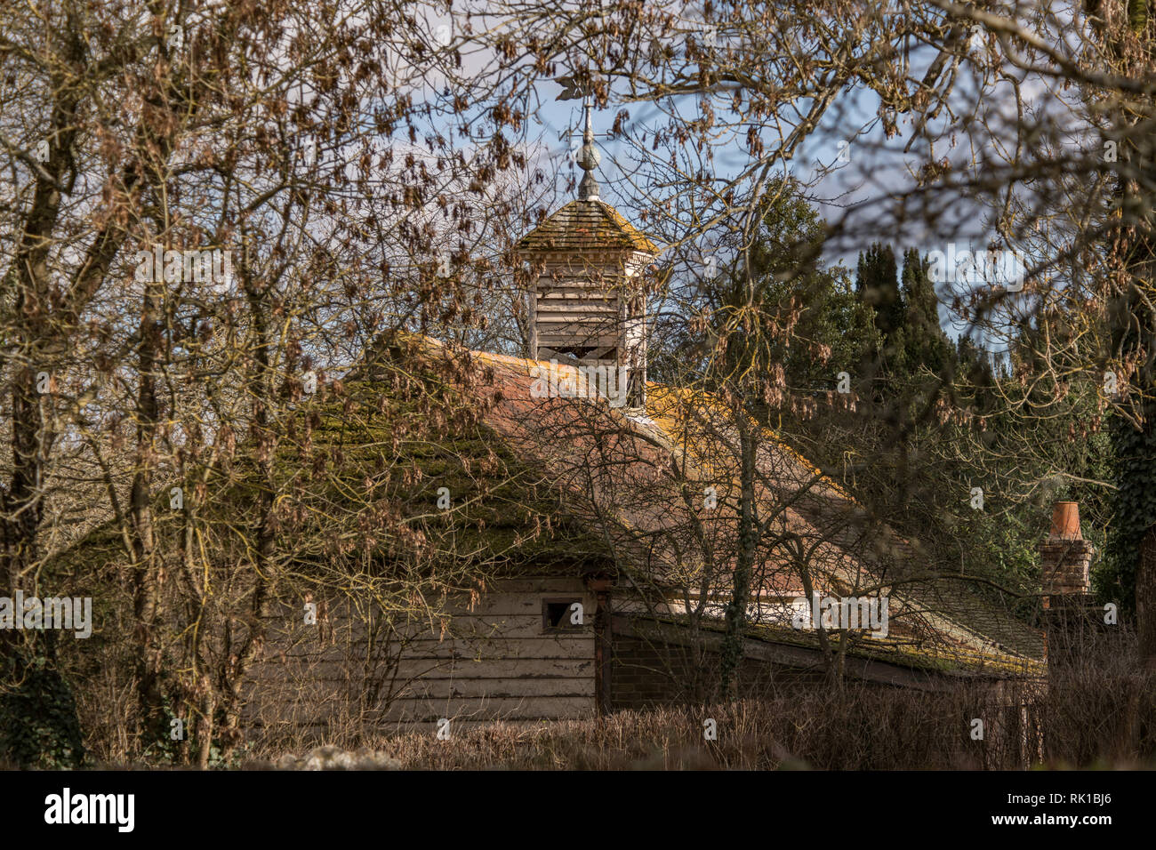 Old out building with clock and weather vane hi-res stock photography ...