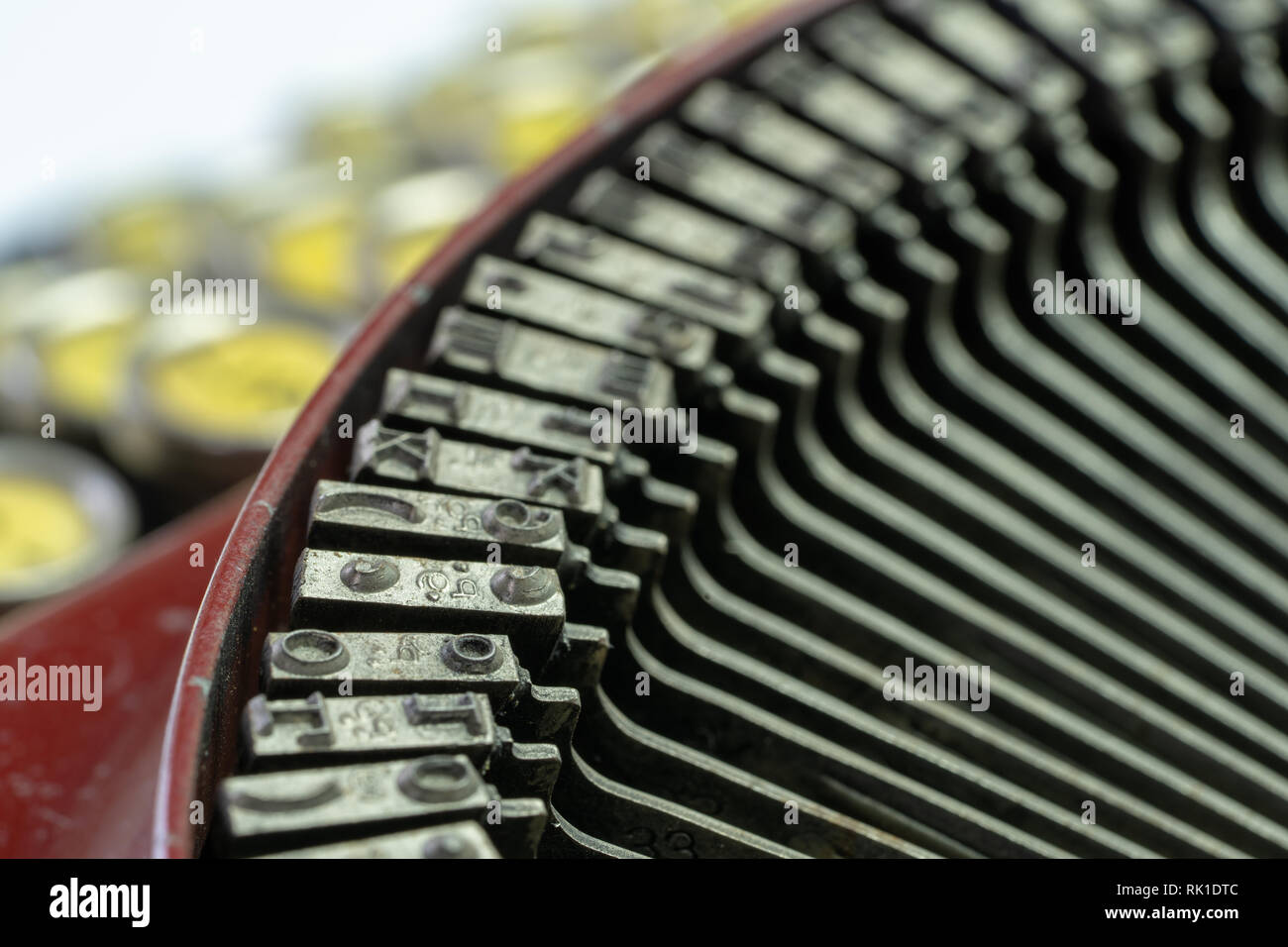 A closeup of the letter blocks on the striker arms of an antique ...
