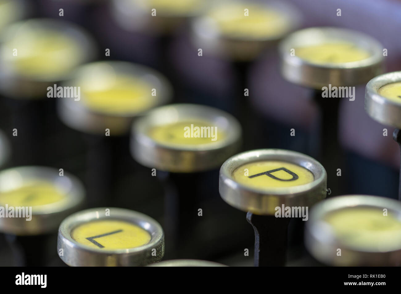 A closeup of the keys on an antique typewriter focusing on the letter P ...
